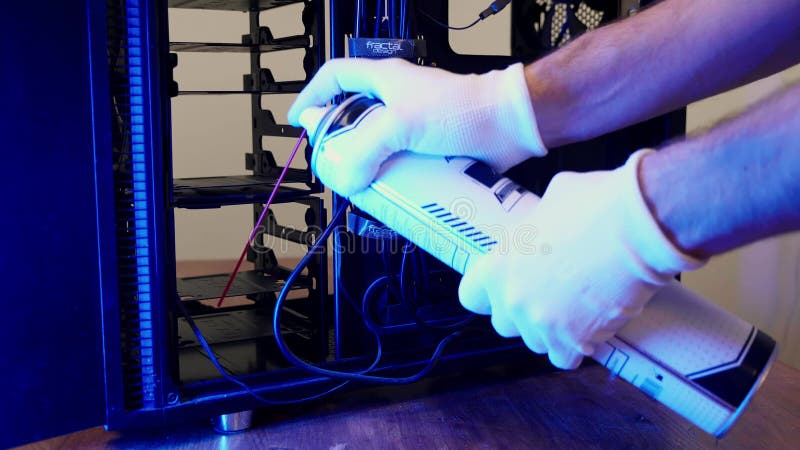 Technician Cleaning Computer with Vacuum Cleaner in Dark Work Shop ...