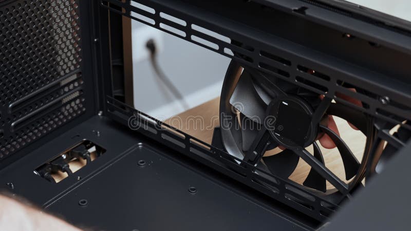 A Computer Technician Unscrews a that Secures a Fan To a PC Case ...