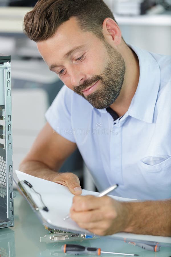 Computer Technician Writing on Clipboard Stock Photo - Image of ...
