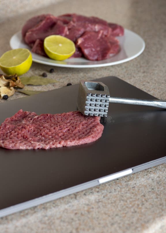 Computer is Used As a Kitchen Board. Meat on Laptop is Ready To Beat ...