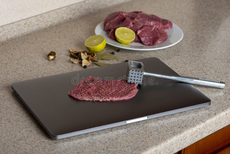 Computer is Used As a Kitchen Board. Meat on Laptop is Ready To Beat ...