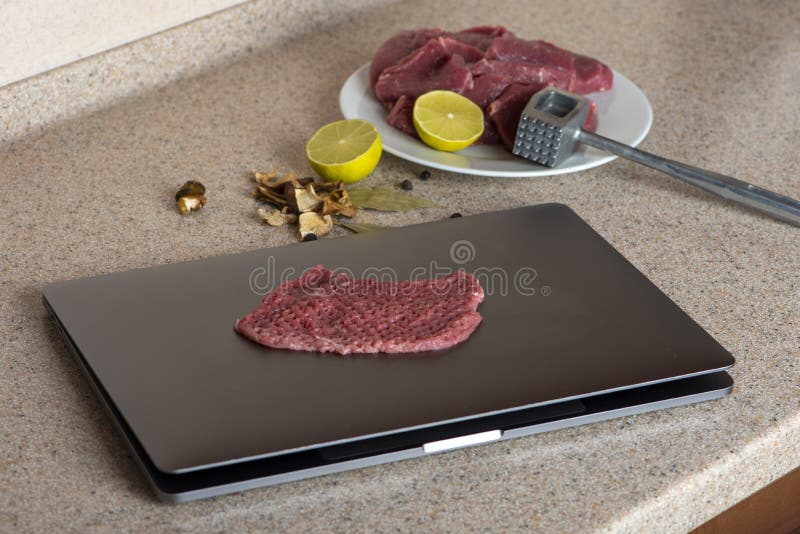 Computer is Used As a Kitchen Board. Meat on Laptop is Ready To Beat ...