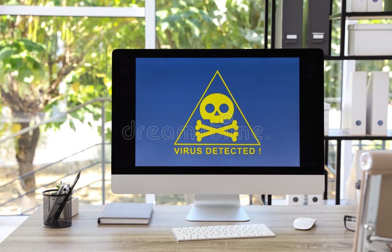 Computer with Warning about Virus Attack on Screen in Office Stock ...