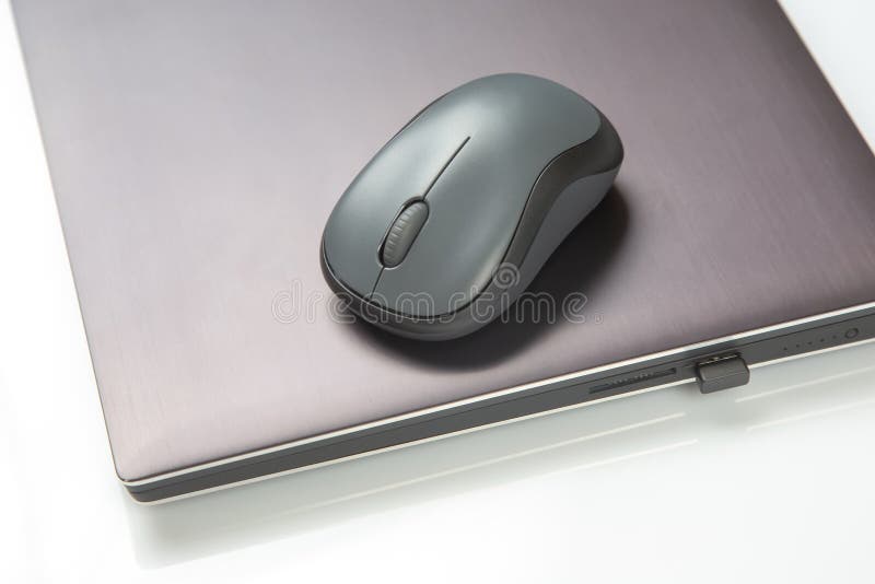 Computer Wireless Mouse Next To a Laptop on a White Table Close-up ...