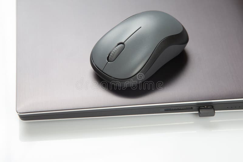 Computer Wireless Mouse Next To a Laptop on a White Table Close-up ...