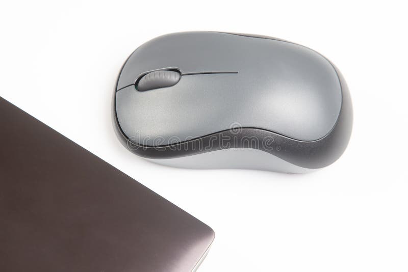 Computer Wireless Mouse Next To a Laptop on a White Table Close-up ...