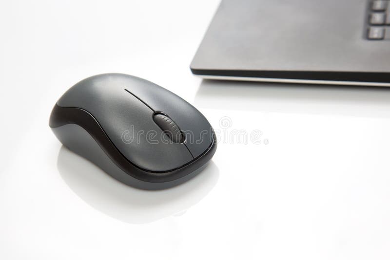 Computer Wireless Mouse Next To a Laptop on a White Table Close-up ...
