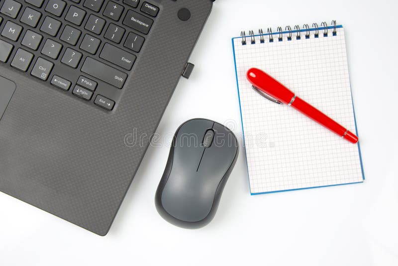 Computer Wireless Mouse, Pen and Notepad Next To a Laptop on a White ...