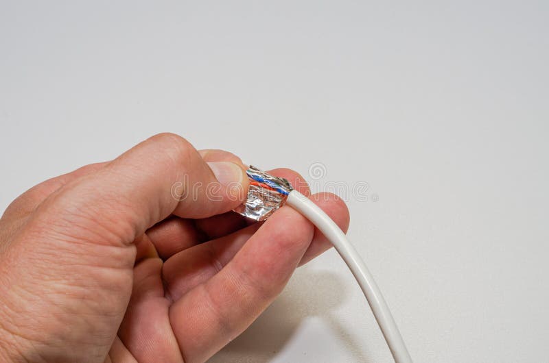 A Computer Wizard Strips the Wires of an Internet Cable for Connecting ...