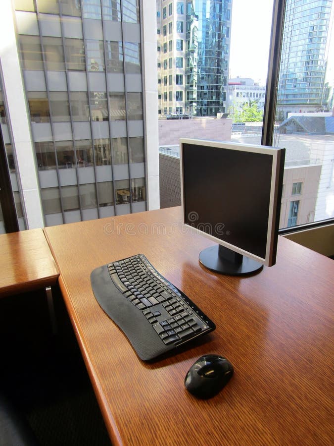 Computer on Wooden Table and City Views from the Glass Wall Stock Photo ...