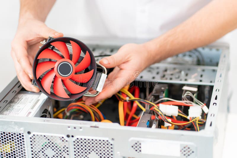 Computer Workshop. Hand of Repairman Installs a Cooler in in a Computer ...