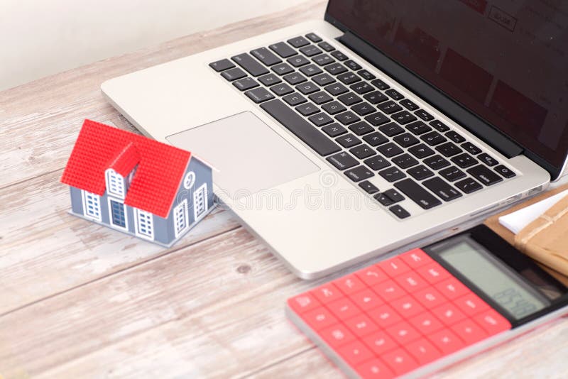 Calculators and Small House Models on Financial Charts Stock Photo ...