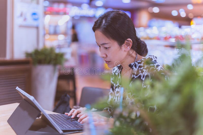 Concentrate Woman Working on Laptop Computer in Coffee Shop. Stock ...