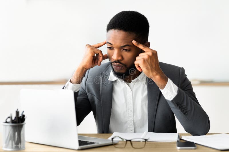 Concentrated African Employee Analyzing Information on Laptop, Working ...
