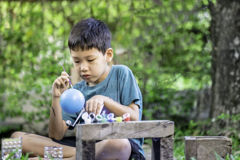 Concentrated Asian Boy Coloring Solar System Toys, Sensory Activity ...