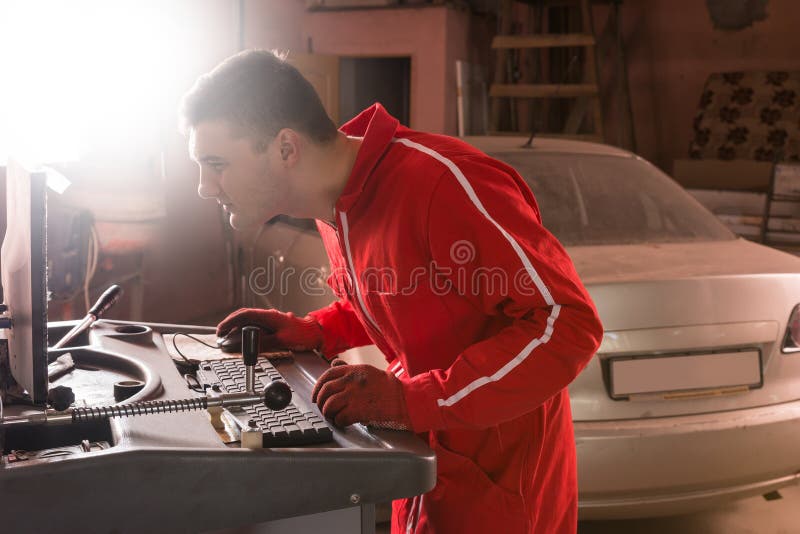 Concentrated Auto Mechanic Checking the Readout on a Computer Stock ...