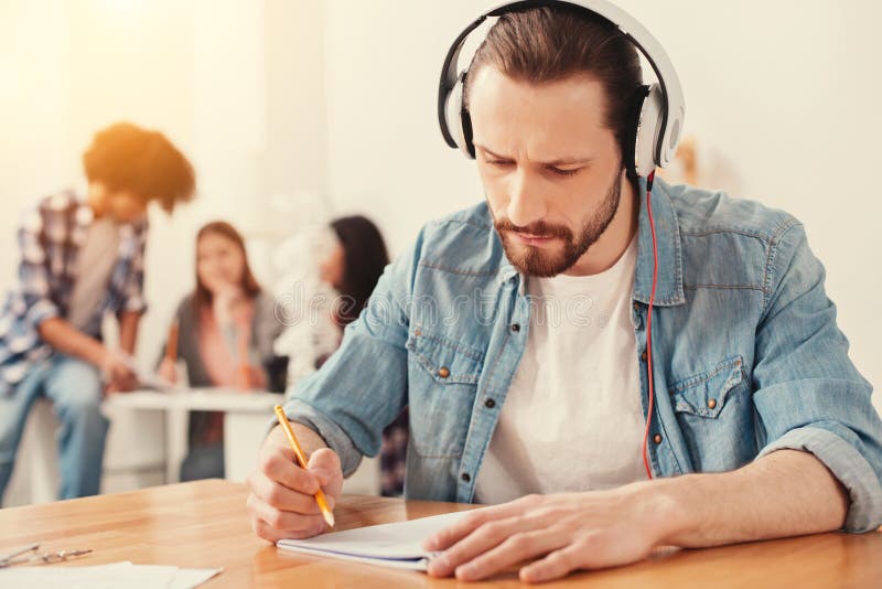 Bearded Man Writing in Notebook at Work Stock Image - Image of bearded ...