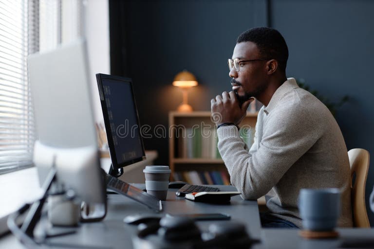 Concentrated Black Man Using Desktop Computer while Working at Desk in ...