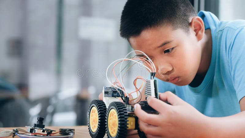 Concentrated Boy Creating Robot at Lab Stock Photo - Image of ...
