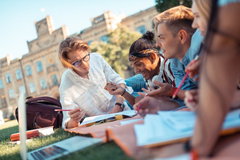 Concentrated Boy Doing Difficult Task Near His Groupmates. Stock Photo ...