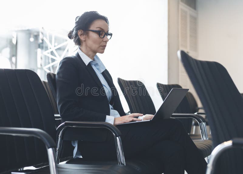 Concentrated Business Coach Preparing for Seminar, Using Laptop Stock ...