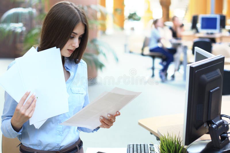 Concentrated Business Lady Comparing Documents at Office. Stock Photo ...