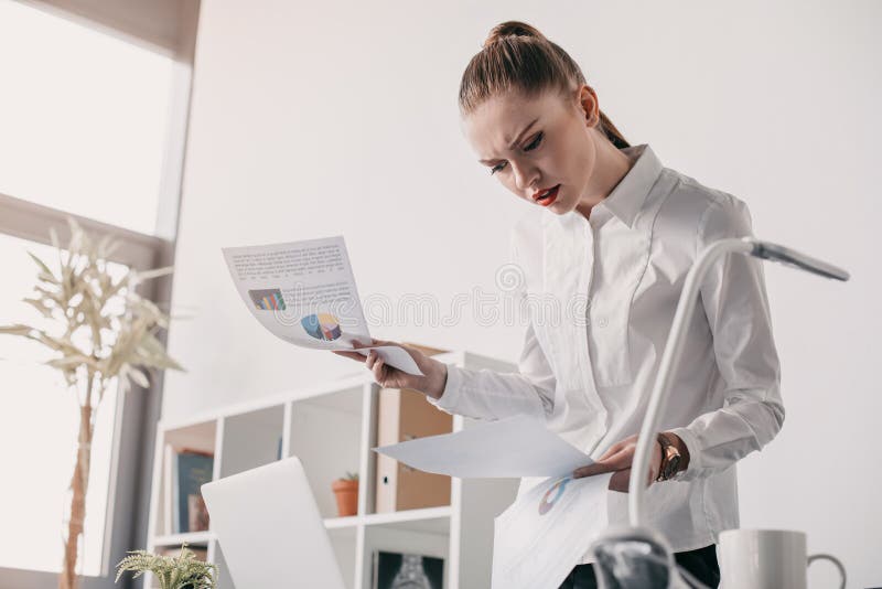 Concentrated Businesswoman Reading Business Documents in Office Stock ...