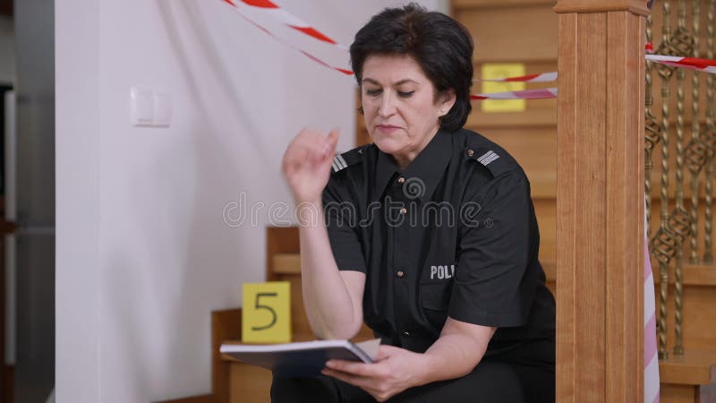 Wide Shot Portrait Of Confident Female Police Officer Holding Hands Of