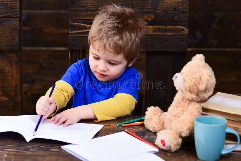 Concentrated Child Pupil Drawing. Busy Kid Writing in Exercise Book ...