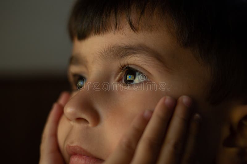 Concentrated Child Watching Something on a Screen Stock Image - Image ...