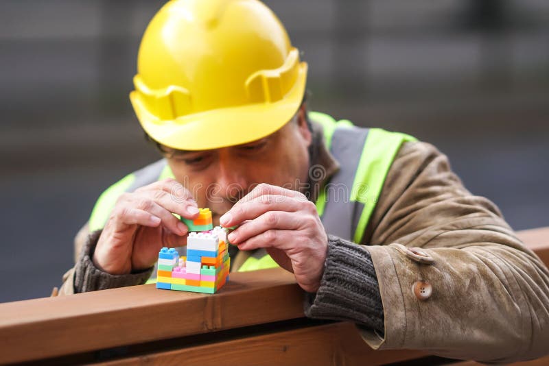 Construction Worker Using Colourful Toy Bricks Stock Image - Image of ...