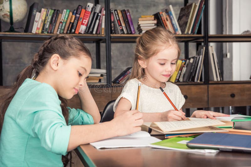 Concentrated Classmates Doing Homework Together in Library Stock Photo ...