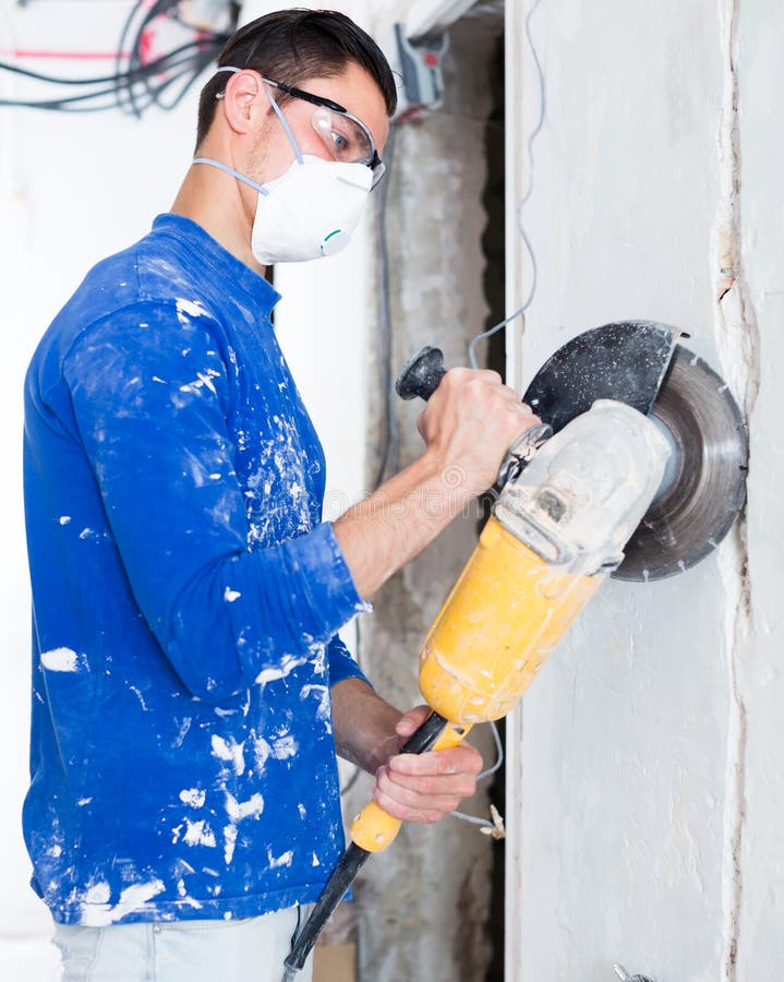 Concentrated Construction Worker Cutting Concrete Wall by Using ...