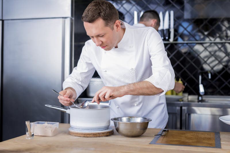 Concentrated Cook Preparing Something Delicious in the Kitchen Stock ...