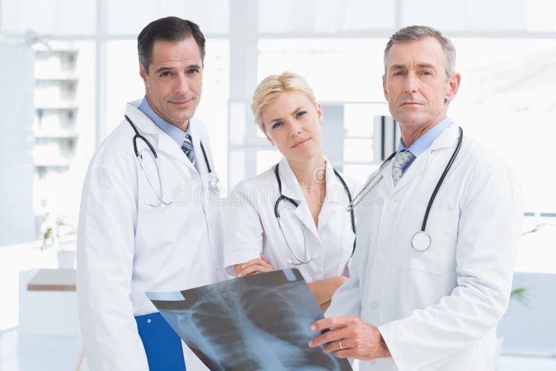 Concentrated Doctors Looking at Camera Stock Photo - Image of people ...