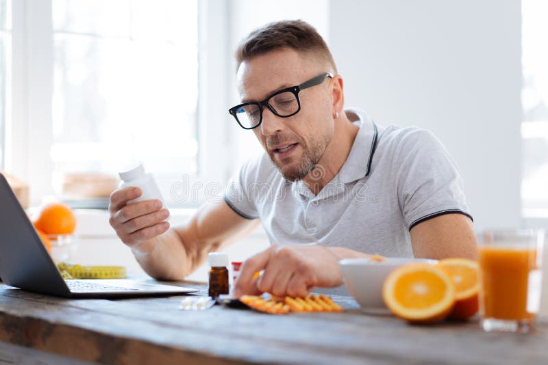 Concentrated Earnest Man Taking Biohacking Supplements Stock Photo ...