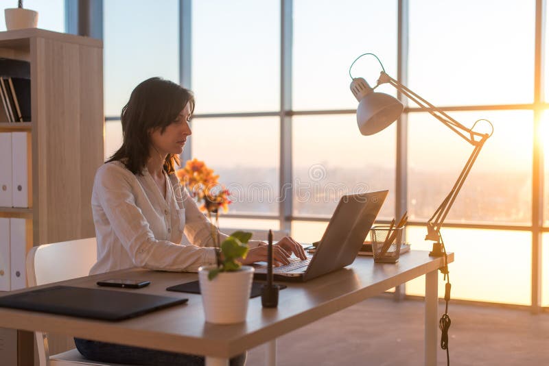 Concentrated Female Employee Typing at Workplace Using Computer. Side ...