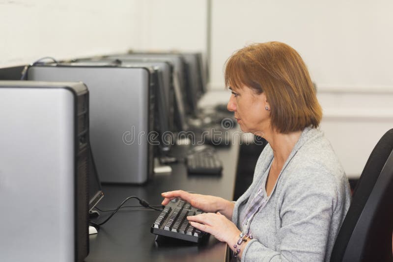 Concentrated Female Mature Student Sitting in Computer Class Stock ...