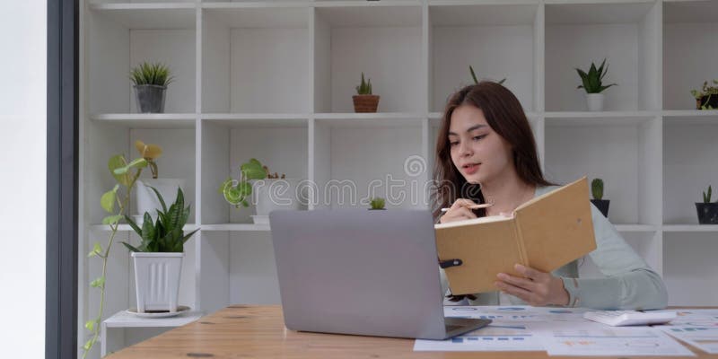 Concentrated Female Student Busy Studying Using Laptop Make Notes in ...