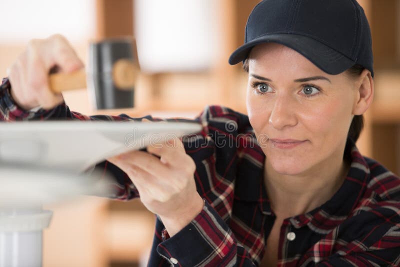 Concentrated Female Worker Using Hammer Stock Photo - Image of ...