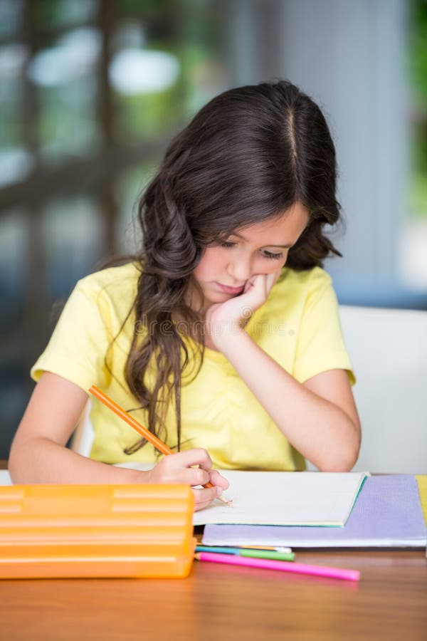 Concentrated Girl Studying while Sitting at Desk Stock Image - Image of ...