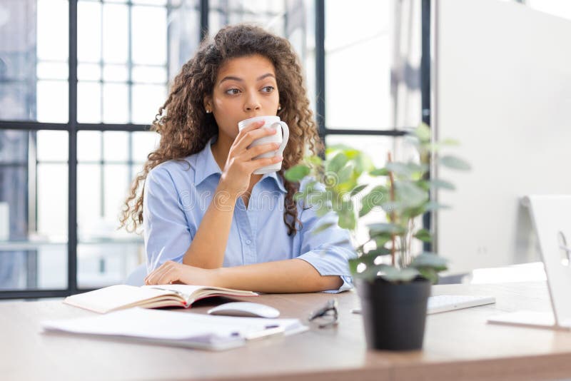 Concentrated Gorgeous Girl Drinking Coffee while Working on Computer ...