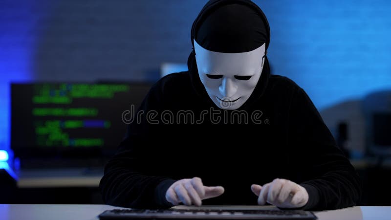 Concentrated Hacker Typing on Keyboard, Raising Masked Face and ...