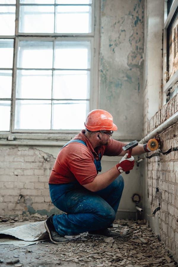Plump Builder on a Construction Site Working on a Brick Wall with a ...