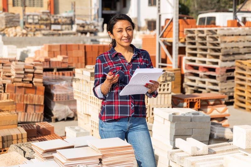 Female Worker Checking Quantity of Paving Slabs in Warehouse Stock ...