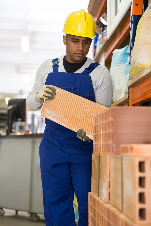Hispanic Worker Stacking Bricks in Warehouse of Building Materials ...