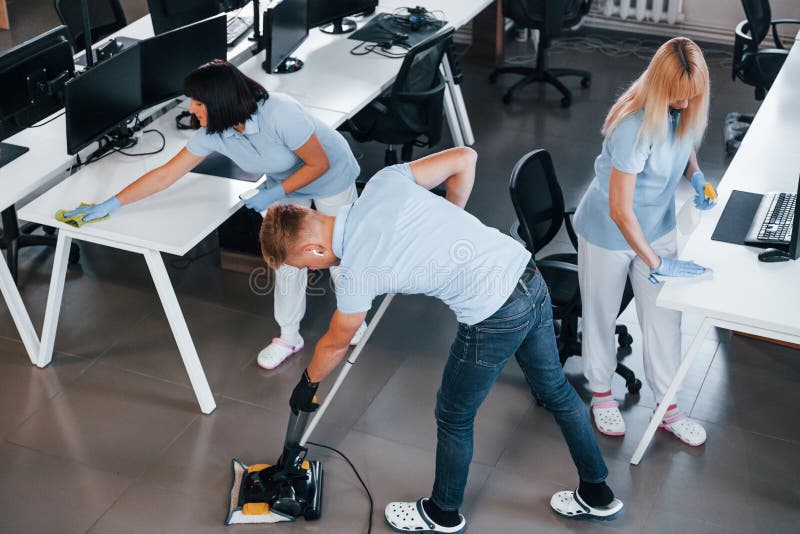 Concentrated at Job. Group of Workers Clean Modern Office Together at ...