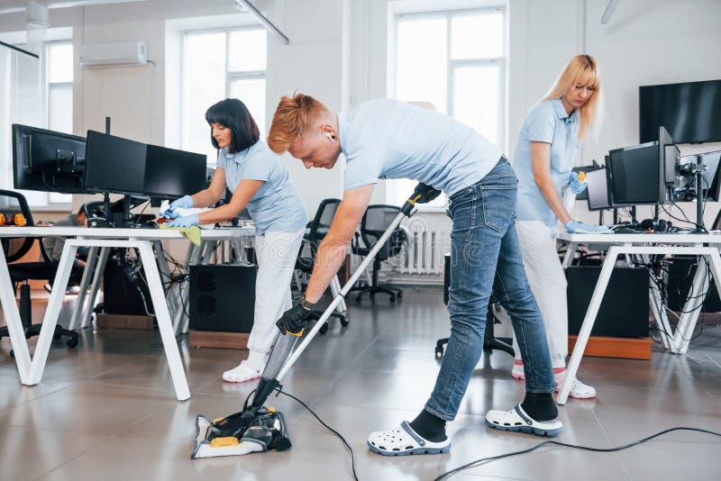 Concentrated at Job. Group of Workers Clean Modern Office Together at ...