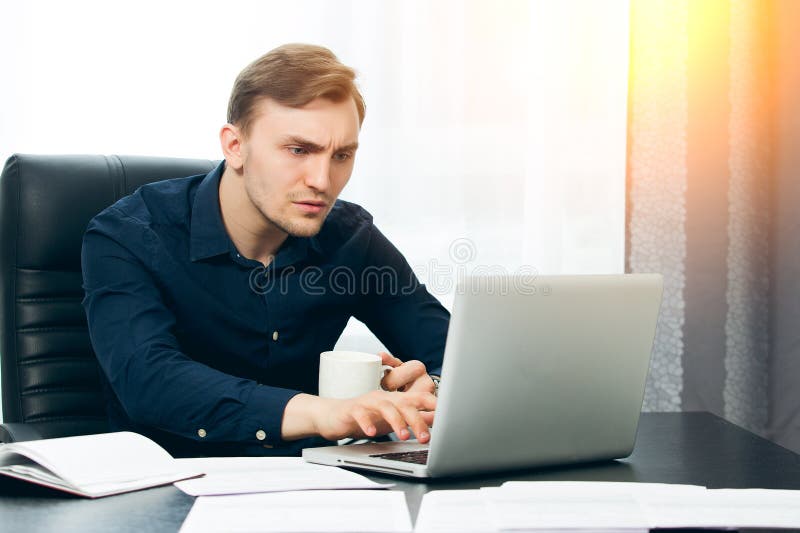 Concentrated Journalist Making an Article with Coffee in Hand Stock ...