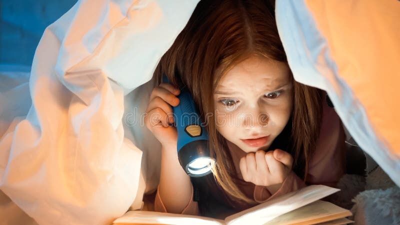 Concentrated Kid with Flashlight Reading Book Stock Image - Image of ...